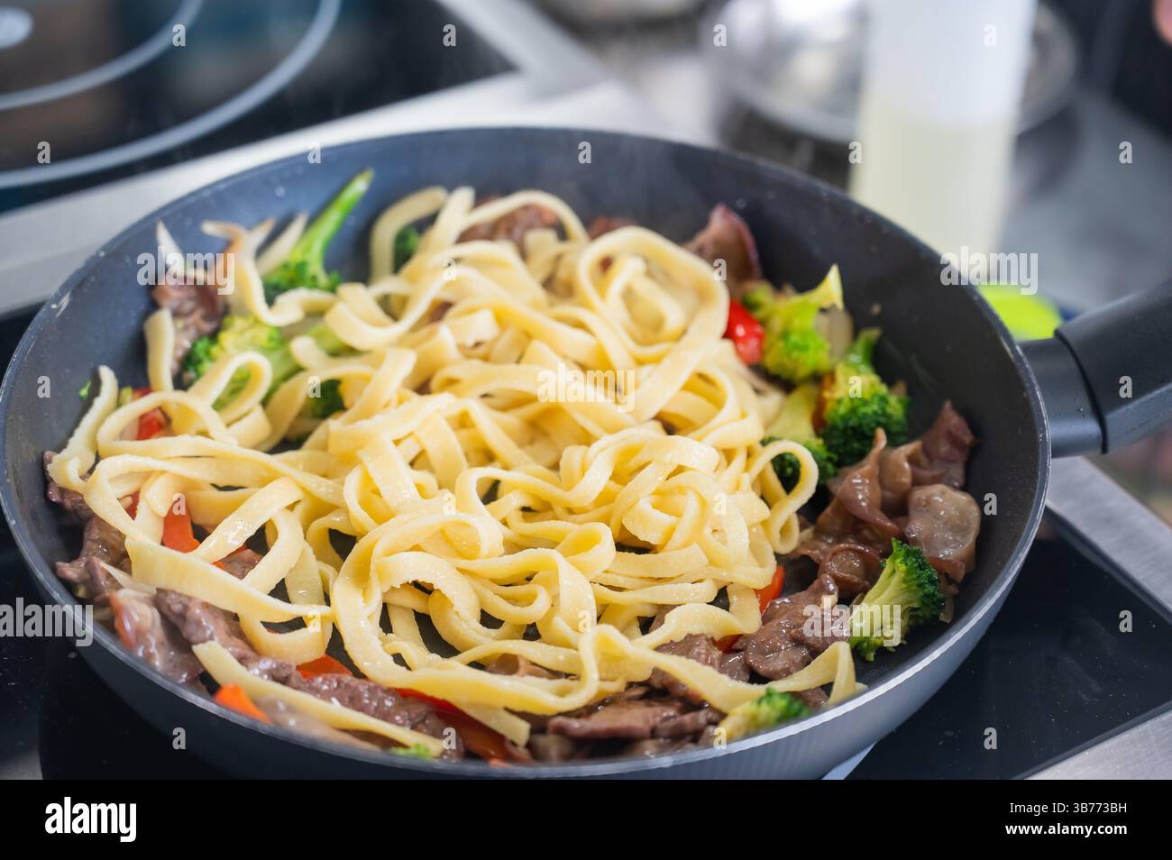 Chef cooks pasta in frying hi-res stock photography and images - Alamy