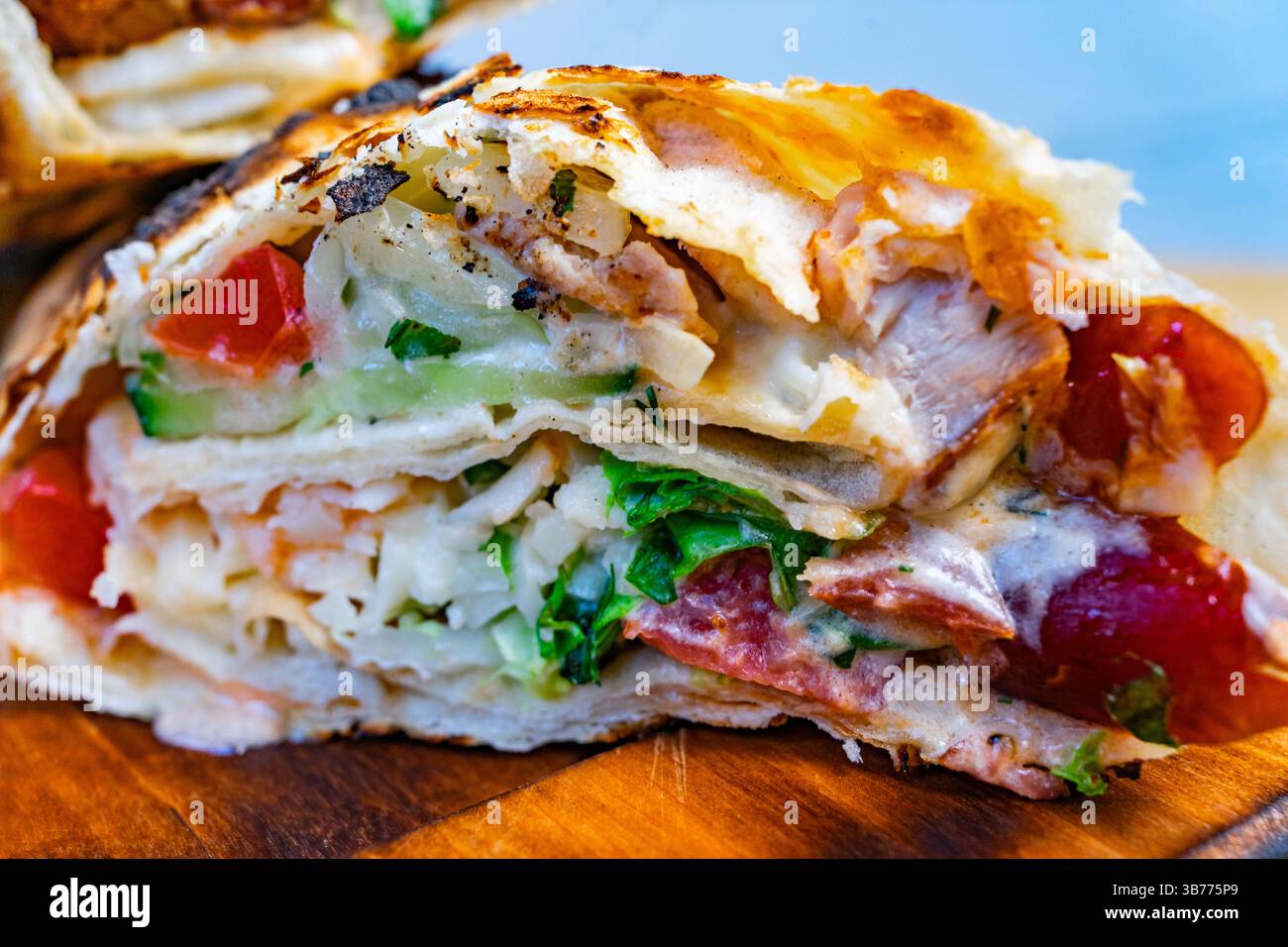 This mouthwatering grilled wrap showcases layers of chicken, fresh ...