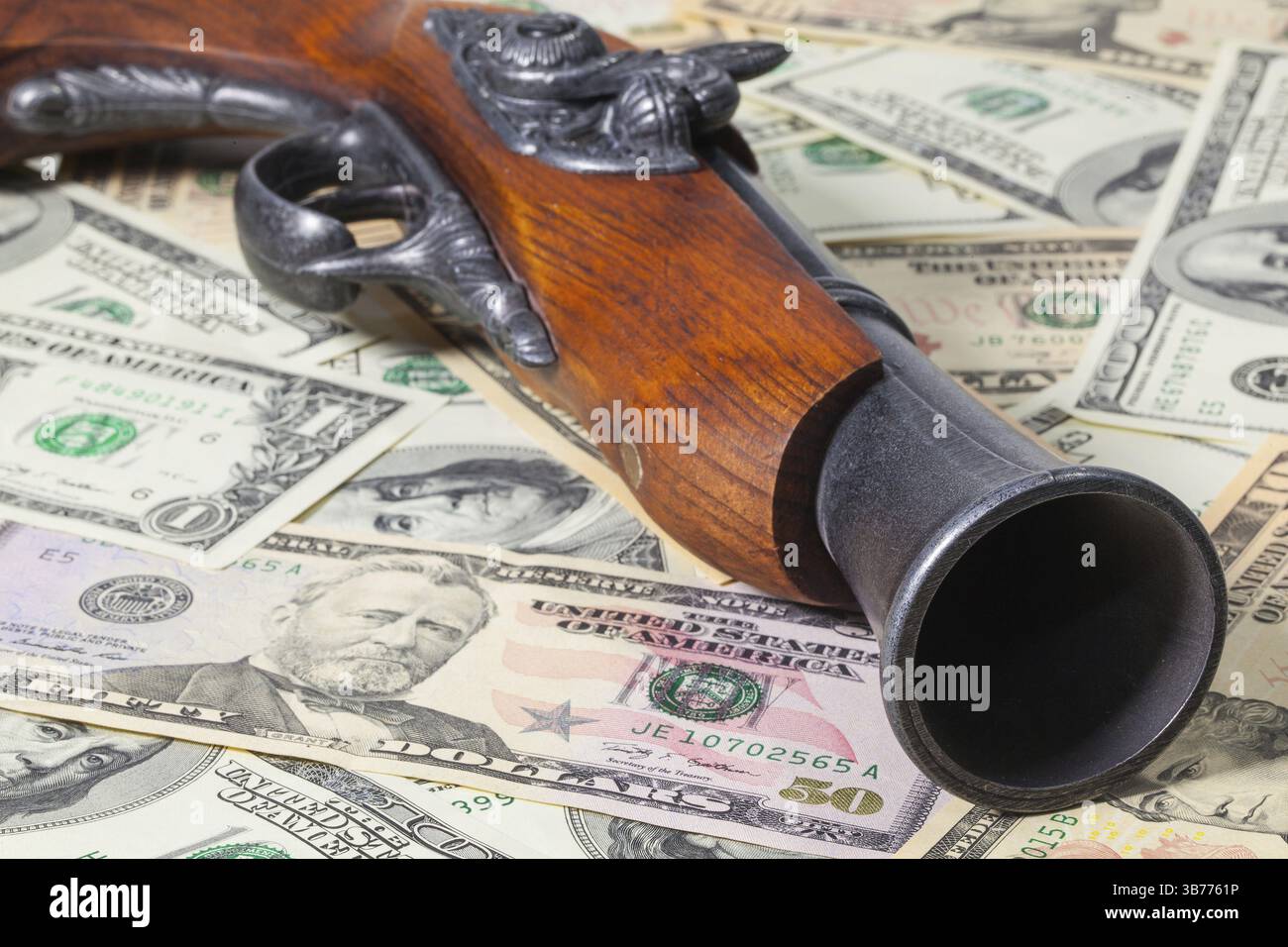 Old gun and dollar bills on the table Stock Photo - Alamy