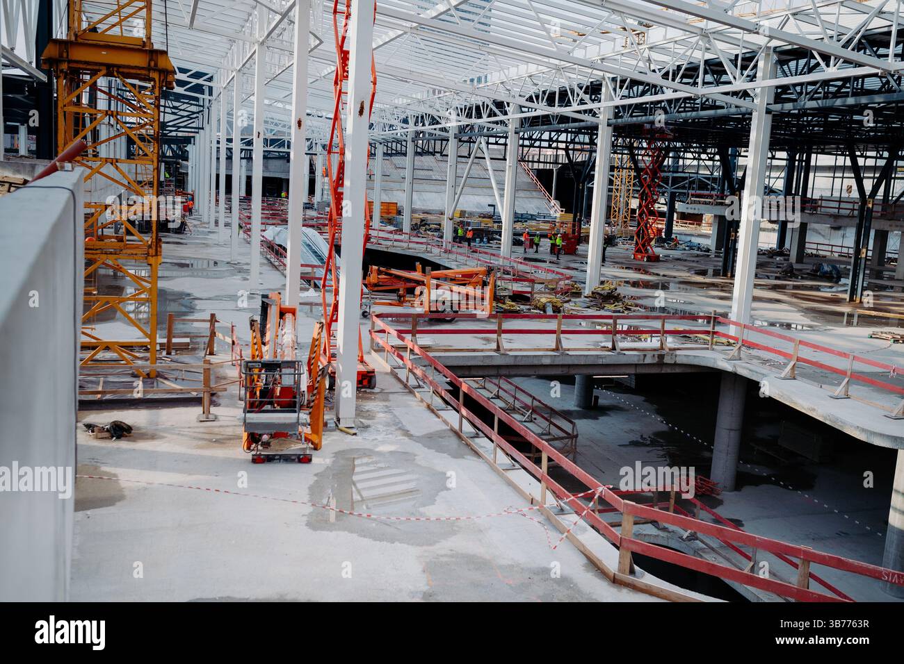 Builders working on structural development at an active construction ...