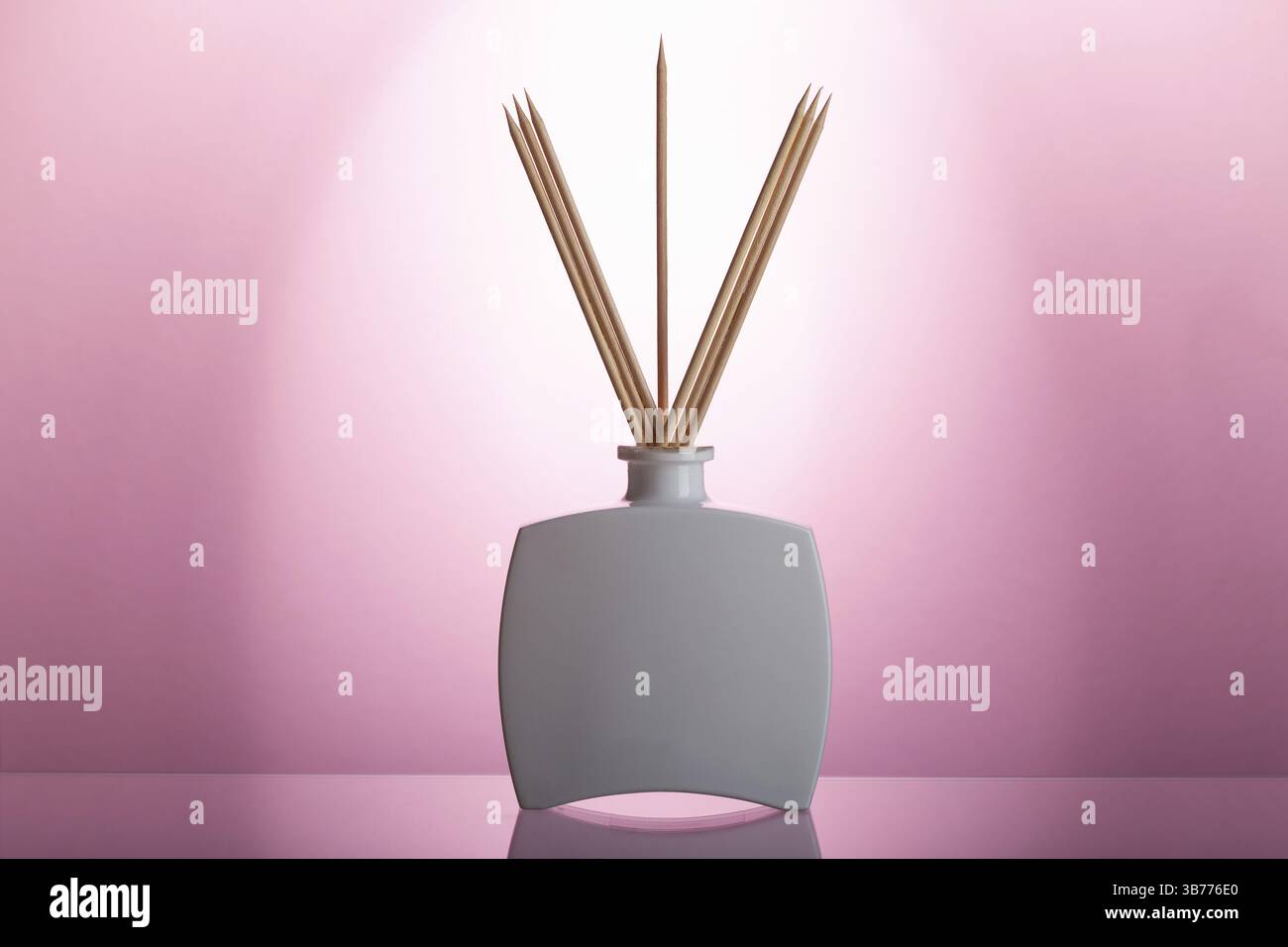 Aromatic reed air freshener on the glass table in the pink bathroom ...