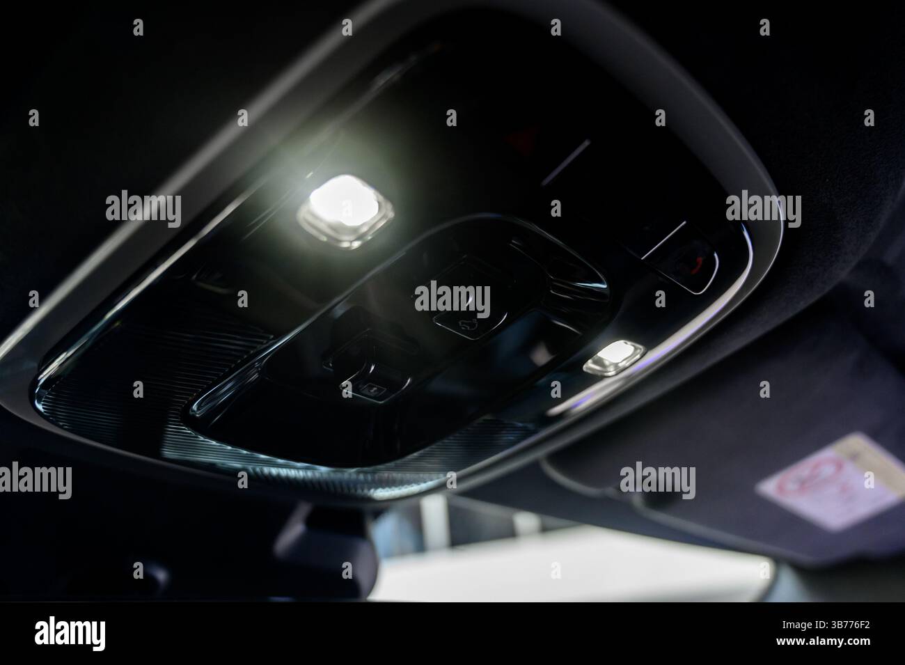 Closeup image of a vehicles overhead control panel showing passenger ...