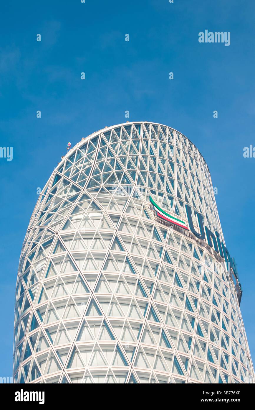 Top of Unipol Tower with geometric glass structure and Italian flag ...