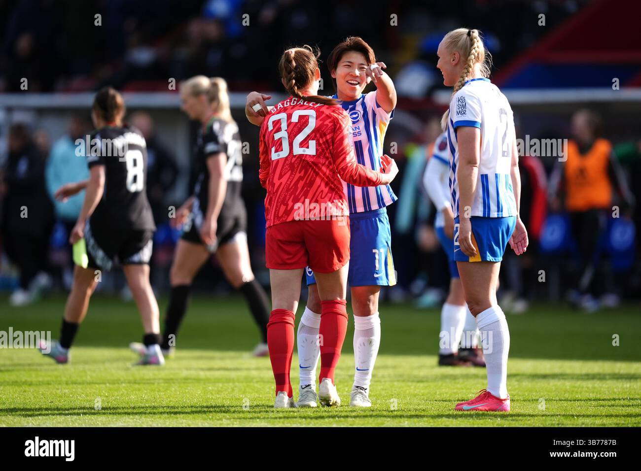 Brighton and Hove Albion goalkeeper Sophie Baggaley hugs Kiko Seike ...