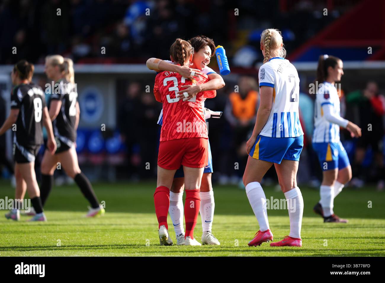 Brighton and Hove Albion goalkeeper Sophie Baggaley hugs Kiko Seike ...