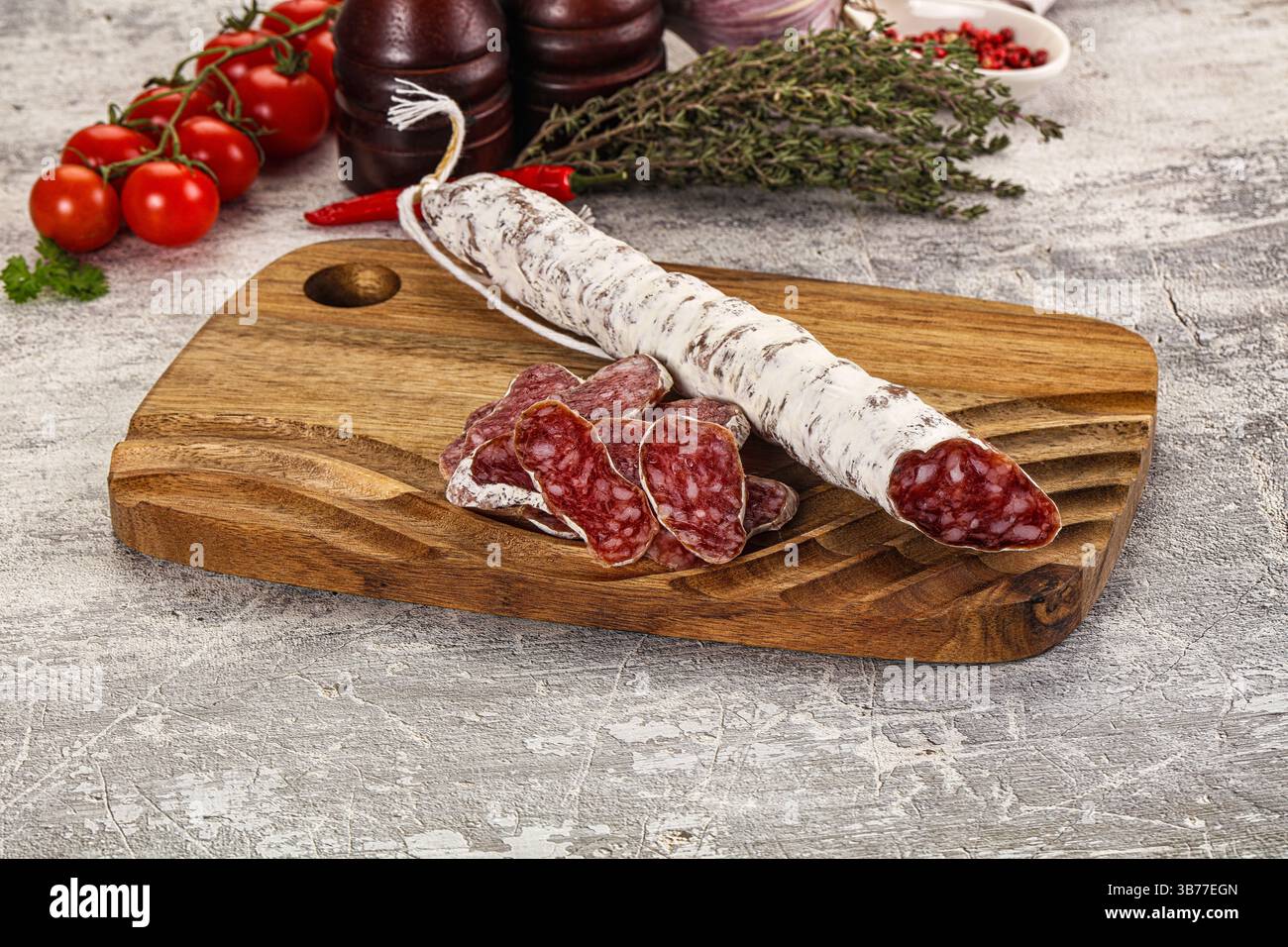 Spanish dry Fuet sausages snack with slices heap Stock Photo - Alamy