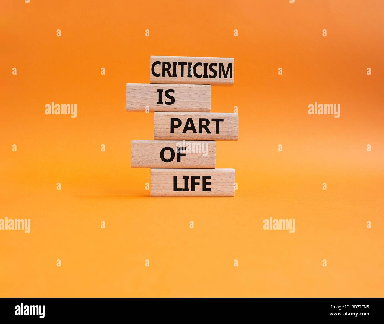 Criticism symbol. Wooden blocks with words Criticism is part of life ...