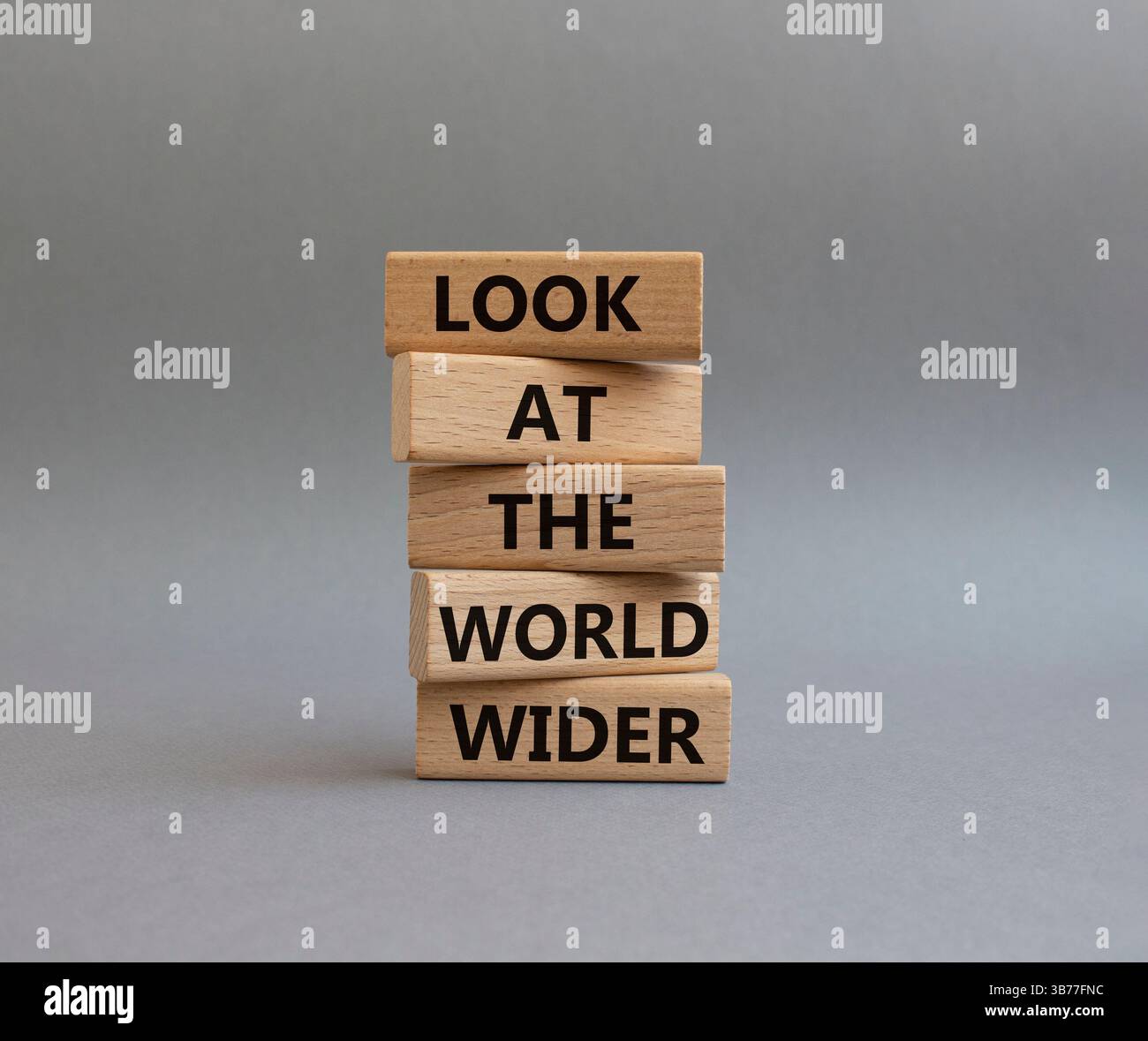 Look at the world wider symbol. Wooden blocks with words Look at the ...