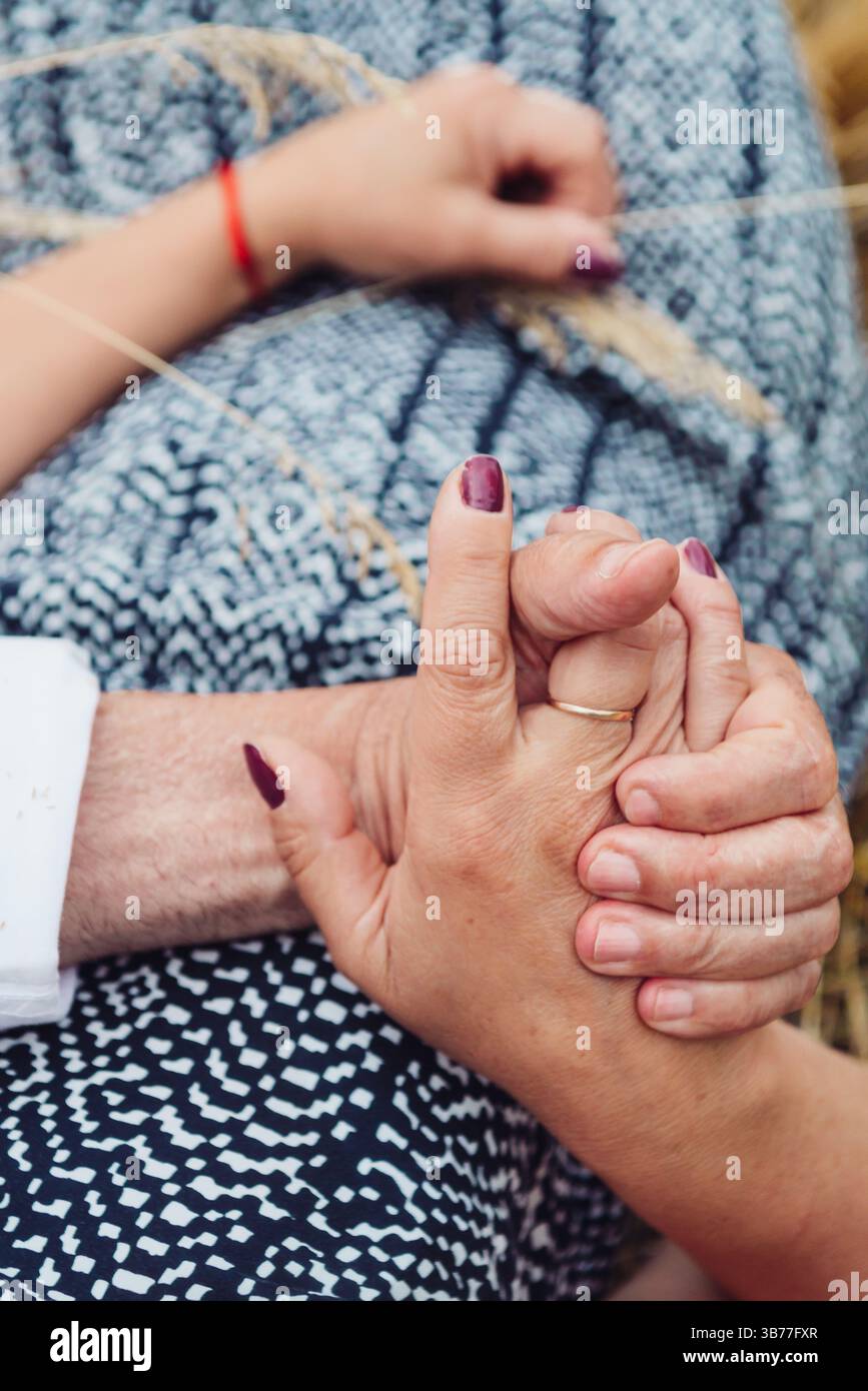 Caring elderly grandma wife holding hand supporting senior grandpa ...