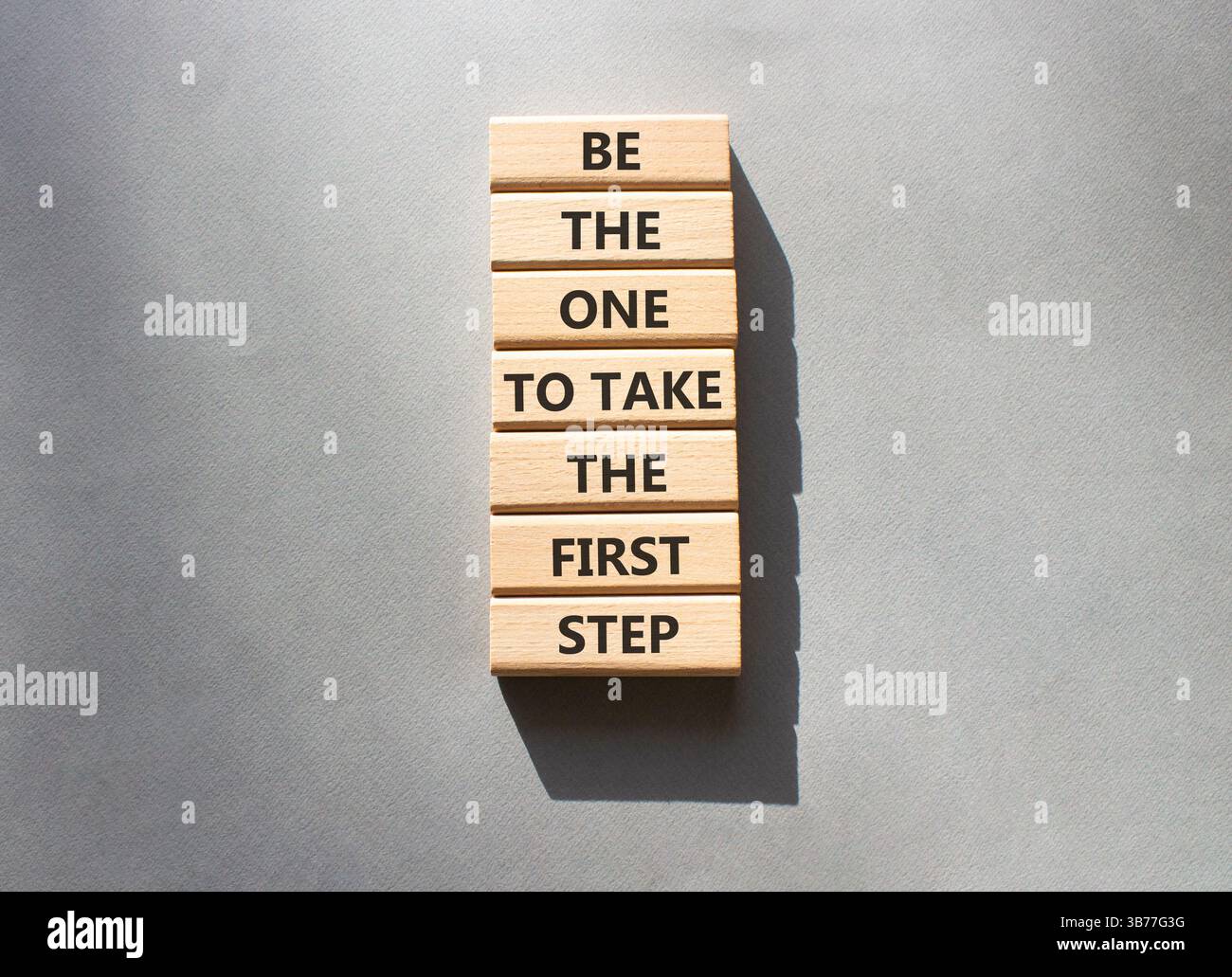 First step symbol. Wooden blocks with words Be the one to take the ...