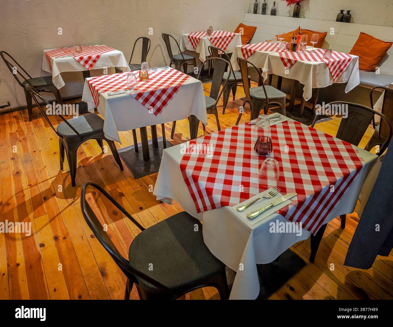 Interior of a modern cozy Italian style restaurant with tables set ...