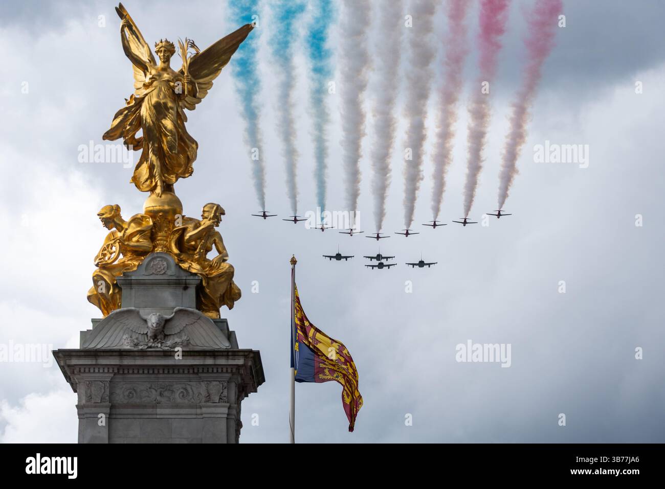 VE Day 80th Anniversary flypast. RAF Red Arrows with four Royal Air ...
