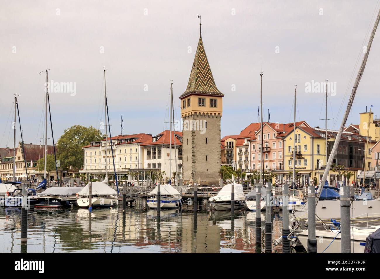 Charming city backdrop, Lindau island with man tower and marina, Lake ...