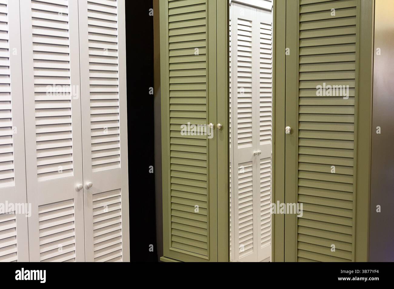 Modern cabinet with louvered doors. Furniture Stock Photo - Alamy