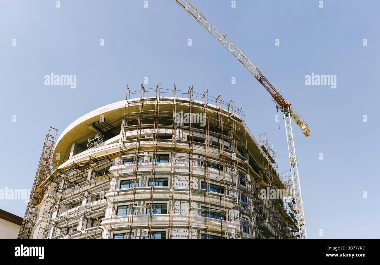 Scaffolding under construction around a modern multi-storey building ...