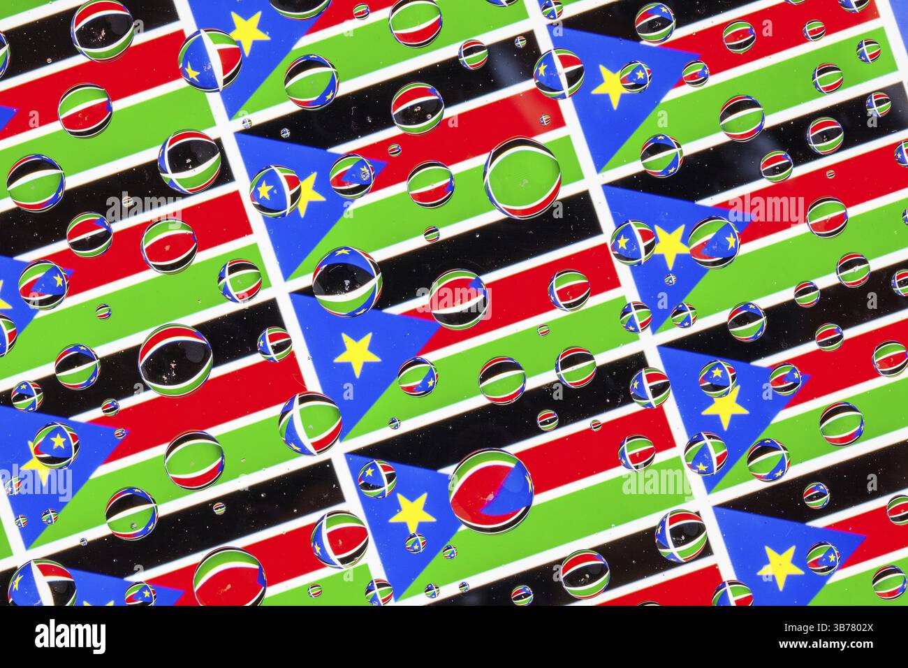 Flags of South Sudan, behind a glass covered with rain drops.Pattern ...