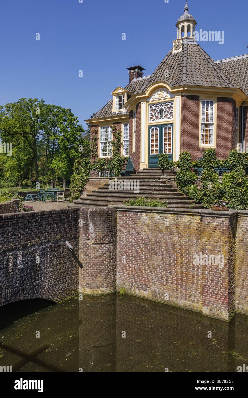 Manor house next to a water canal with typical brick architecture and ...