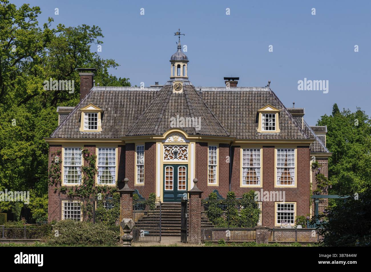 Symmetrical manor house in classic style with decorative details and ...