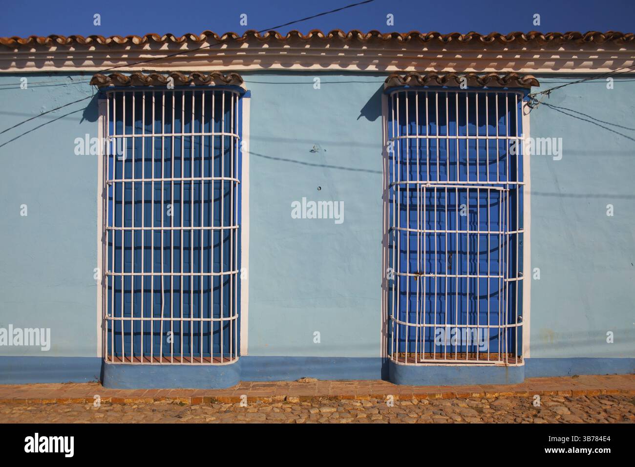 Typical colonial building with white window grate in Trinidad, Cuba ...