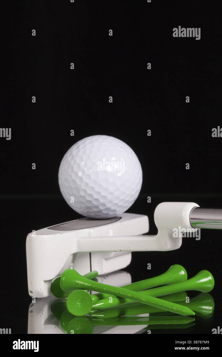 Golf putter and different golf equipments on the black glass desk Stock ...