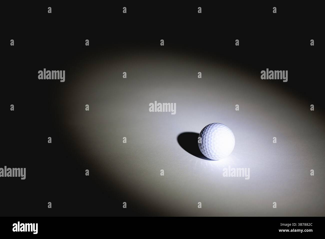 Spotlight and golf ball in the dark room. Spotlight effect for golf ...