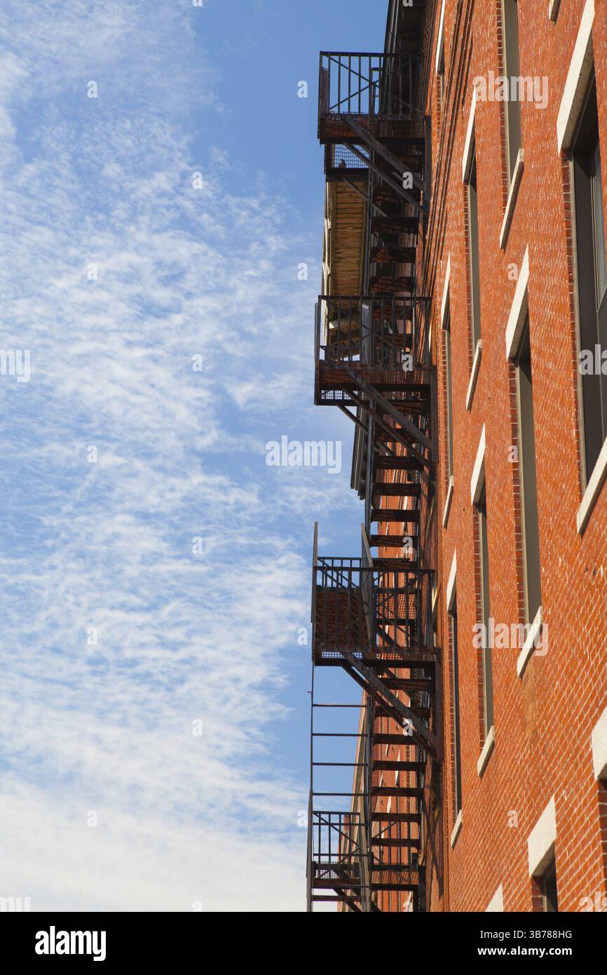 The typical american fire escape ladder zigzagging across the face and ...