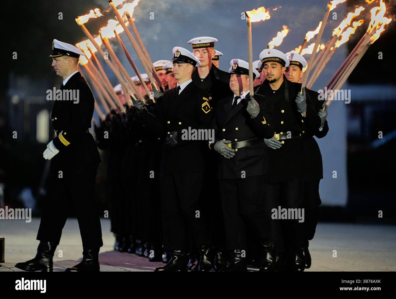 Soldiers with torchlights arrive for a Grand Tattoo ceremony to mark ...