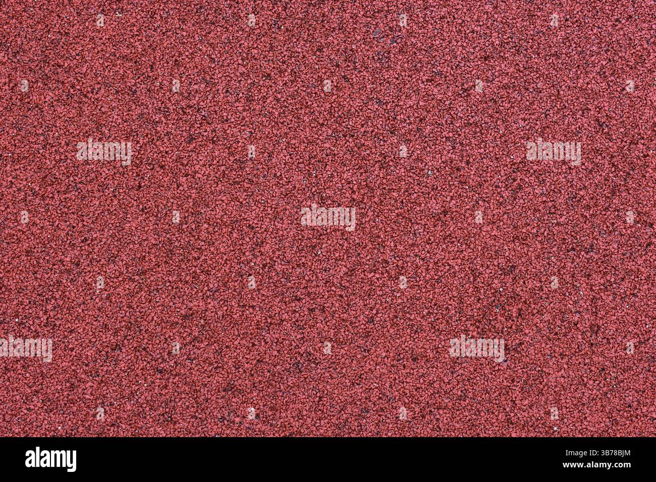 Red sports field rubber coating close up macro view. Playground paving ...