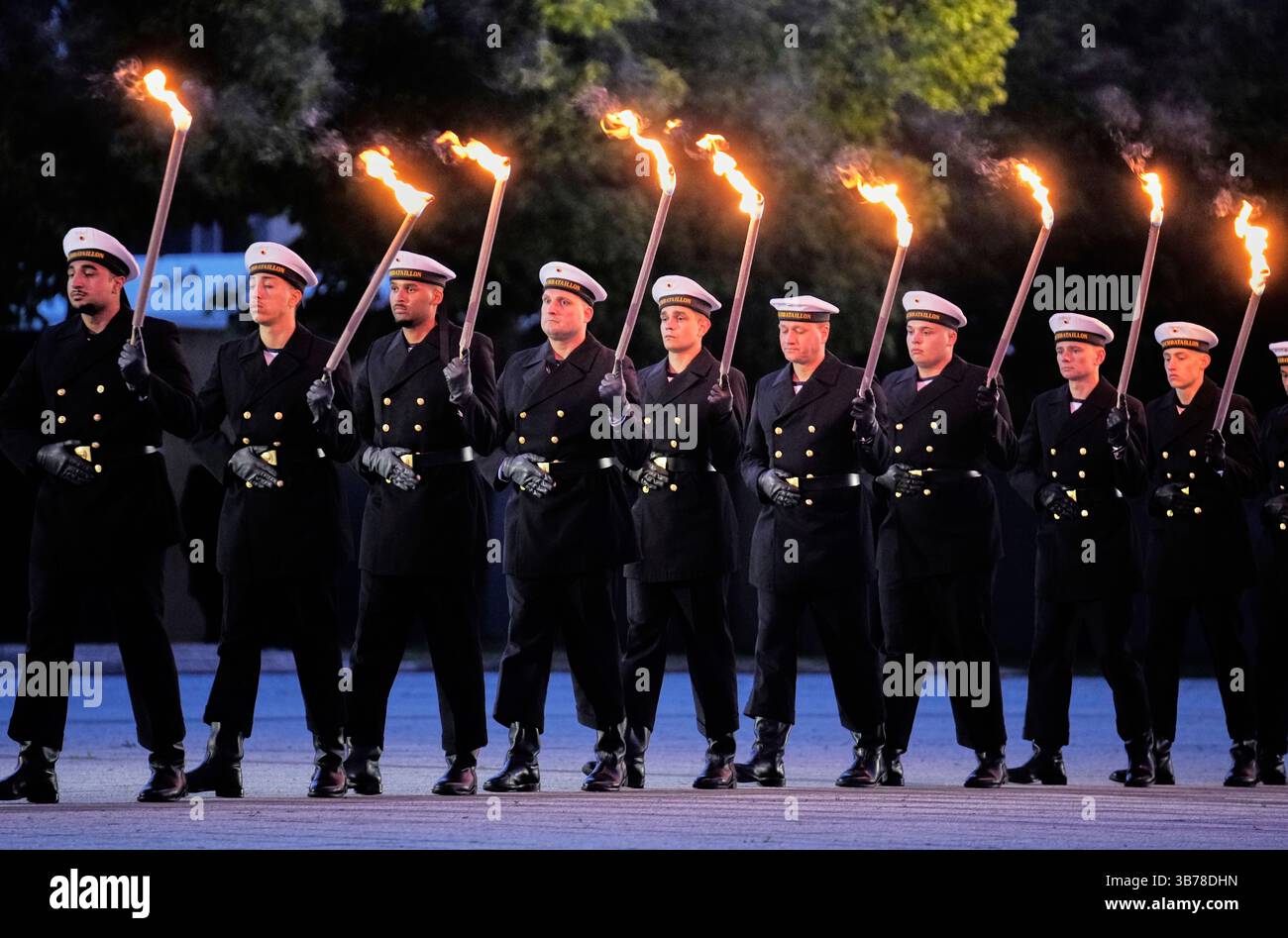 Soldiers with torchlights arrive for a Grand Tattoo ceremony to mark ...