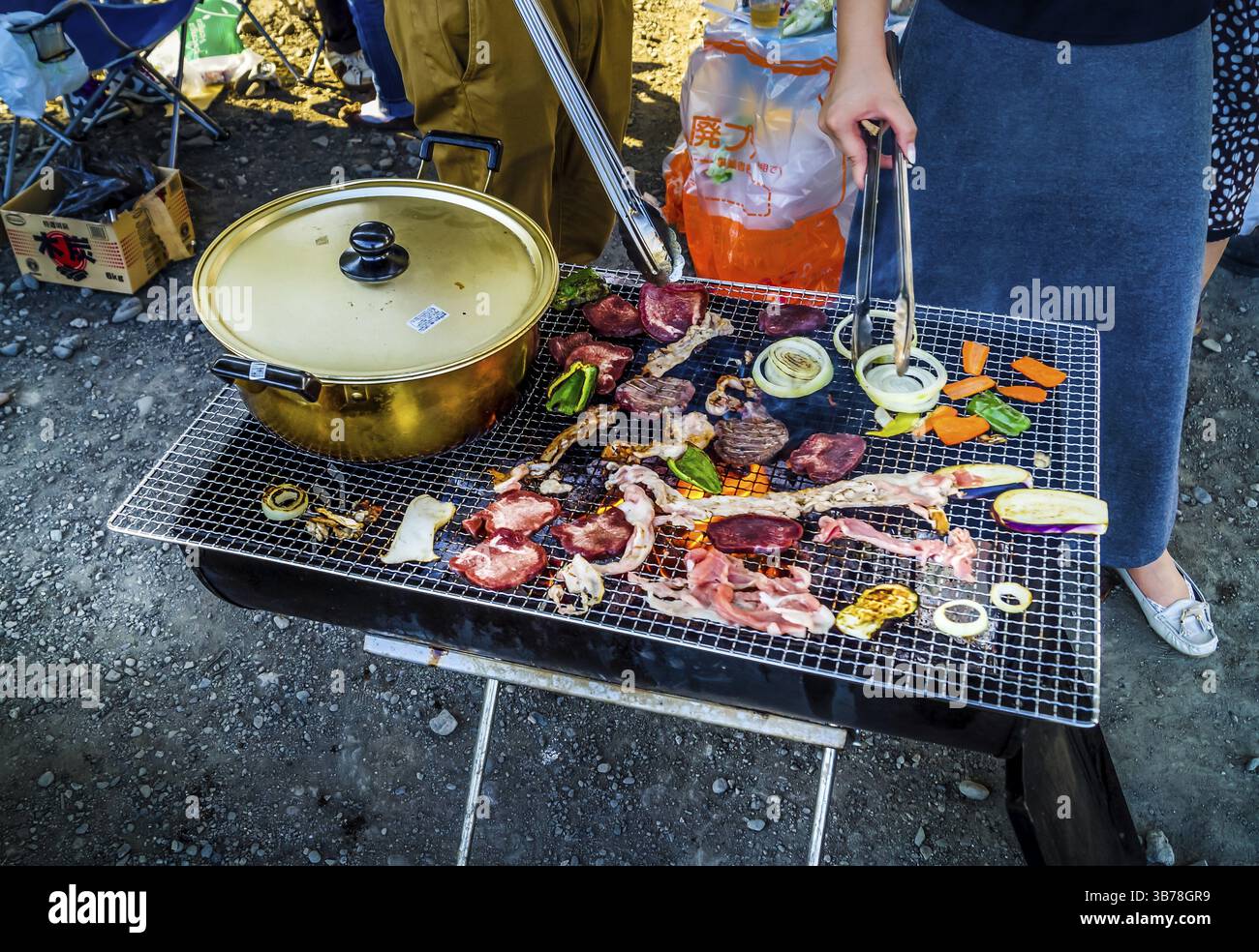 Charcoal-grilled meat image at barbecue. Shooting Location: Tokyo ...