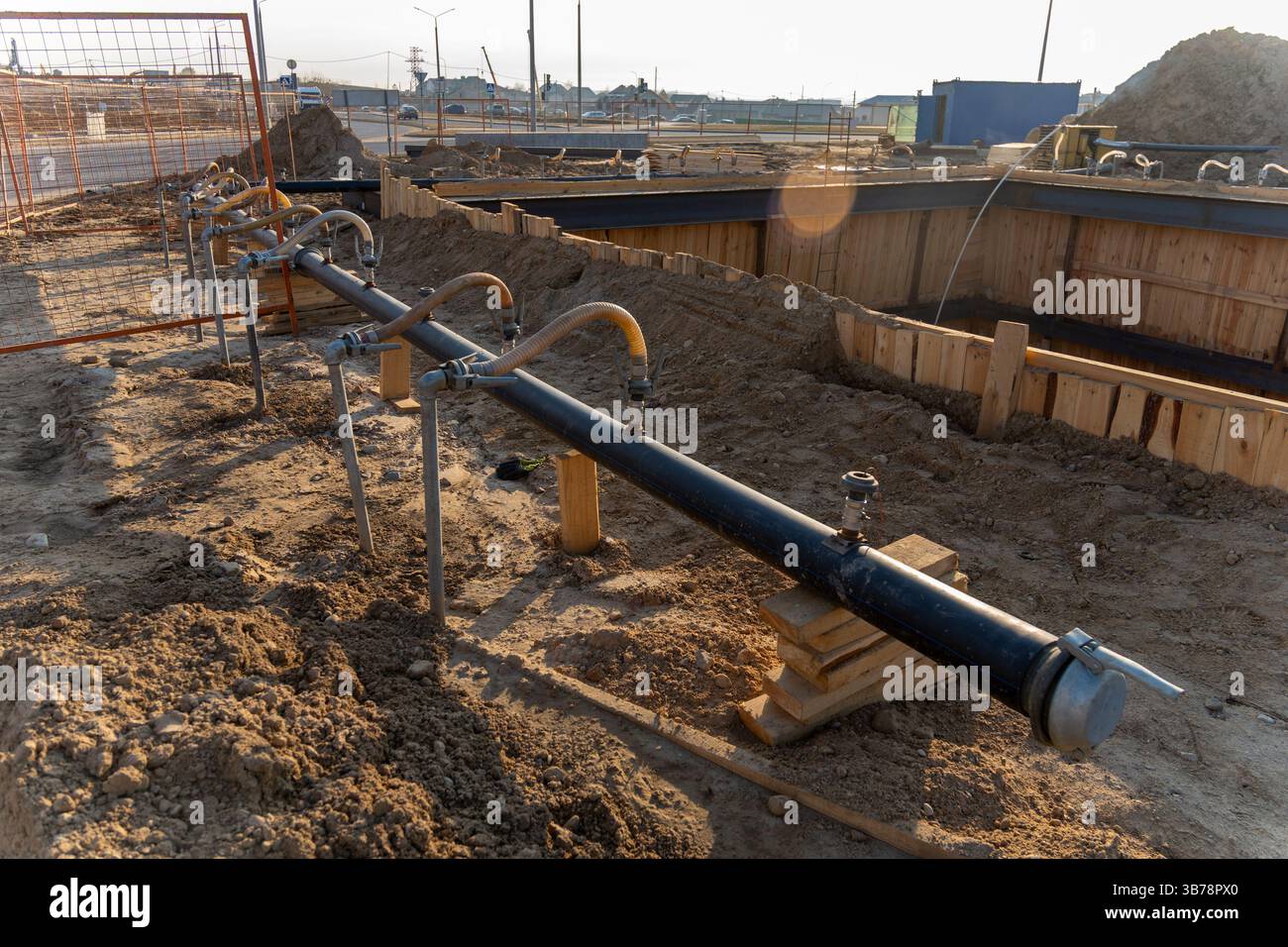 A close-up view of a series of flexible hoses connected to a pipe at a ...