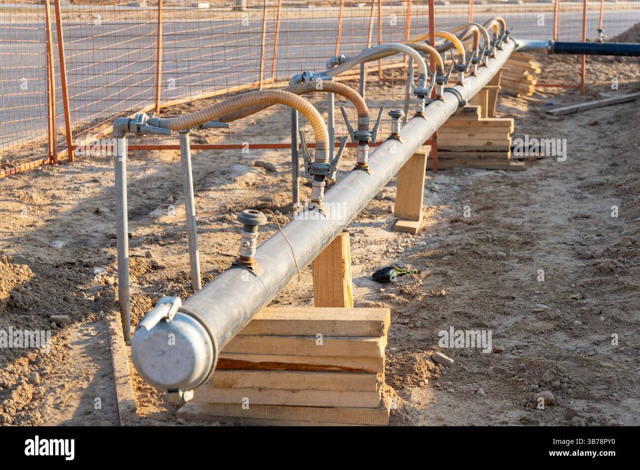 A close-up view of a series of flexible hoses connected to a pipe at a ...