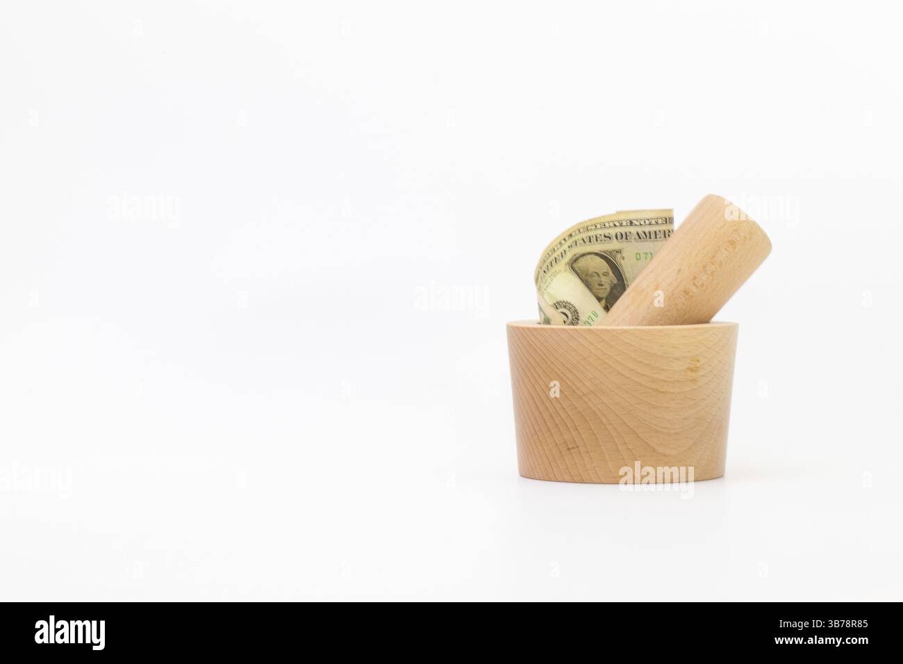 Mortar made of tropical wood and us dollar banknote on white background ...