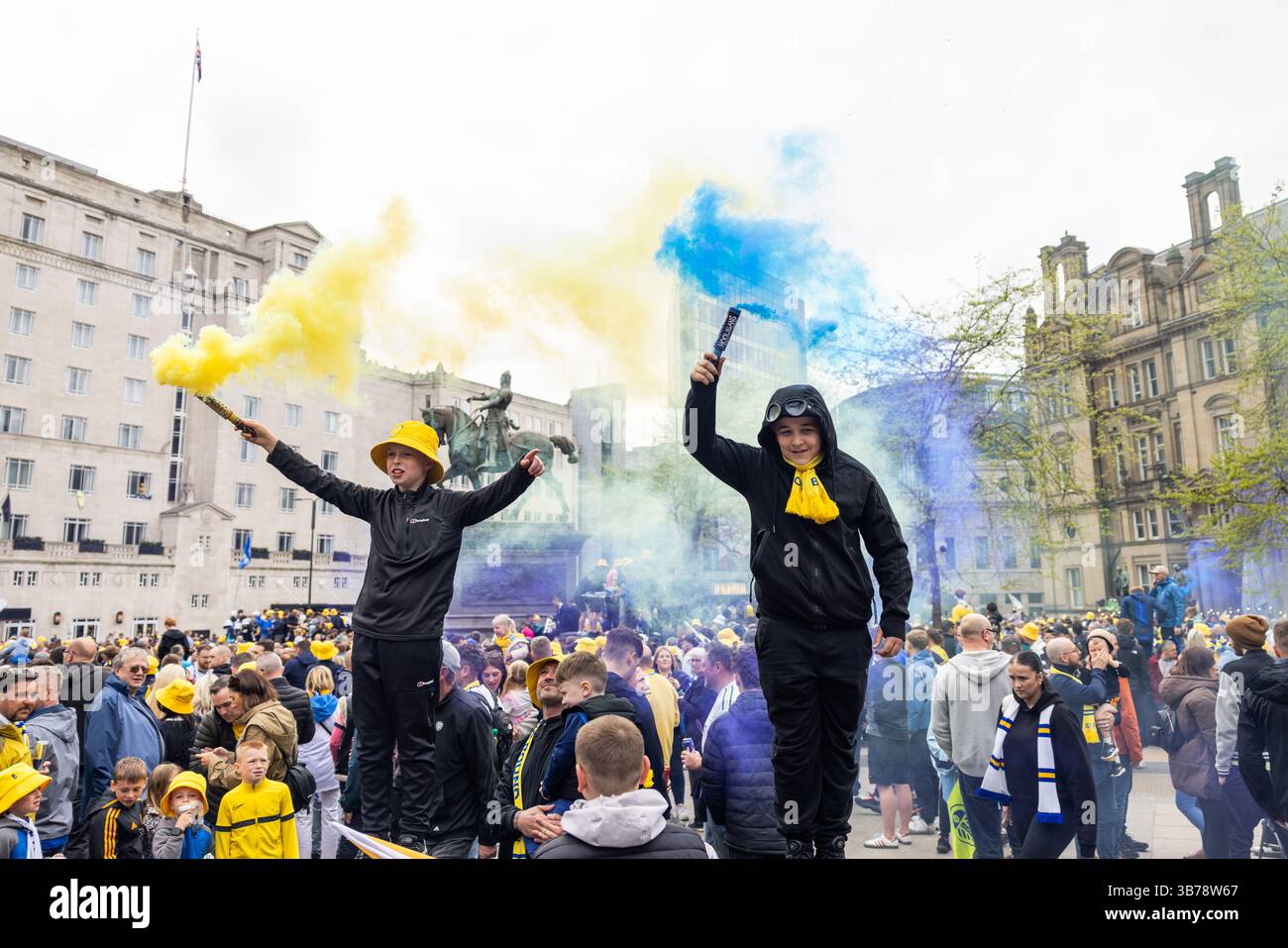Leeds, UK. 05 MAY, 2025. Two boys hold Yellow and Blue flares as Leeds ...