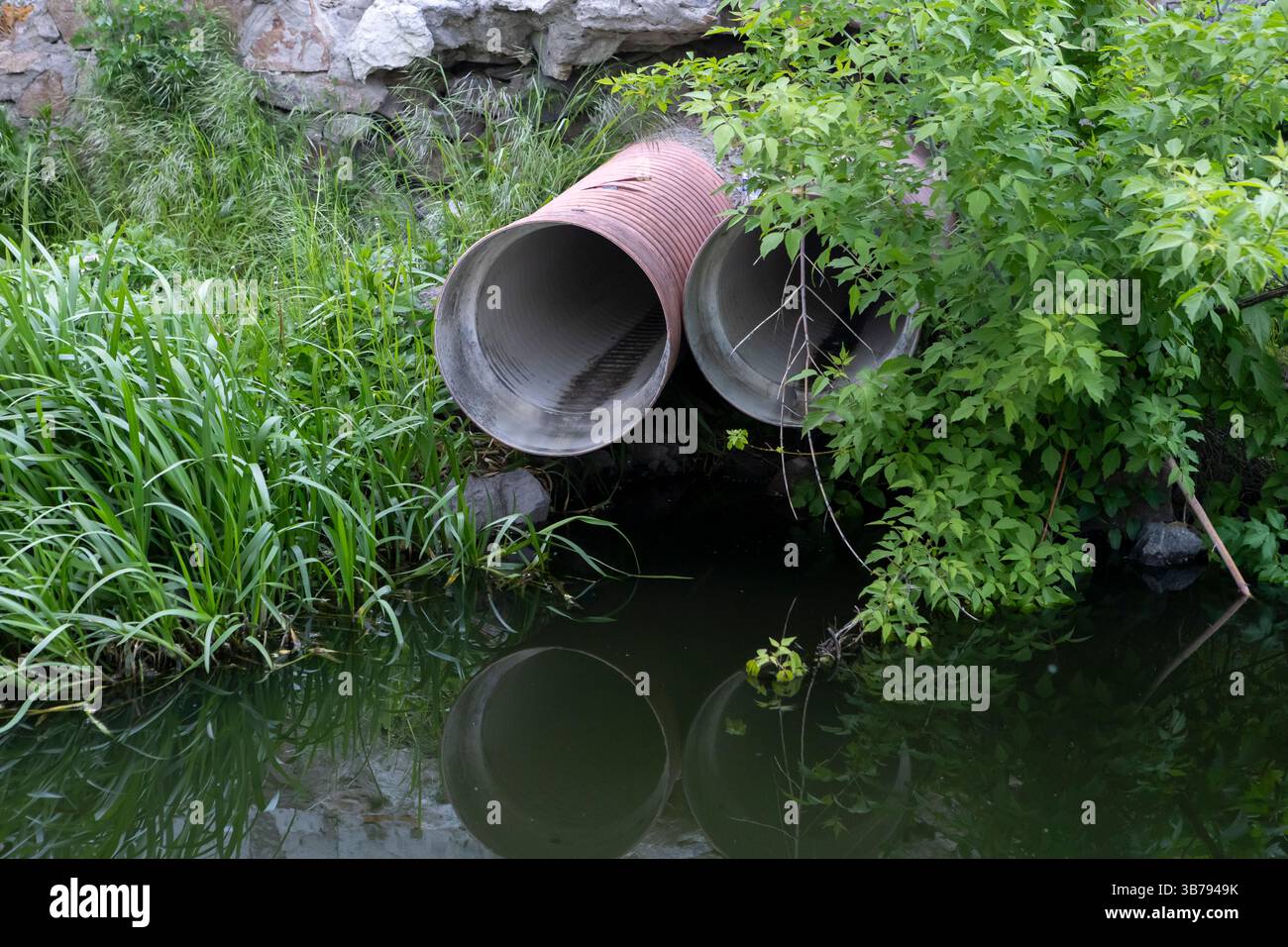 Concrete pipe of the rubble from which water flows into nature. Waste ...
