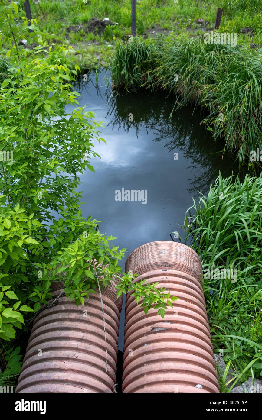 Concrete pipe of the rubble from which water flows into nature. Waste ...
