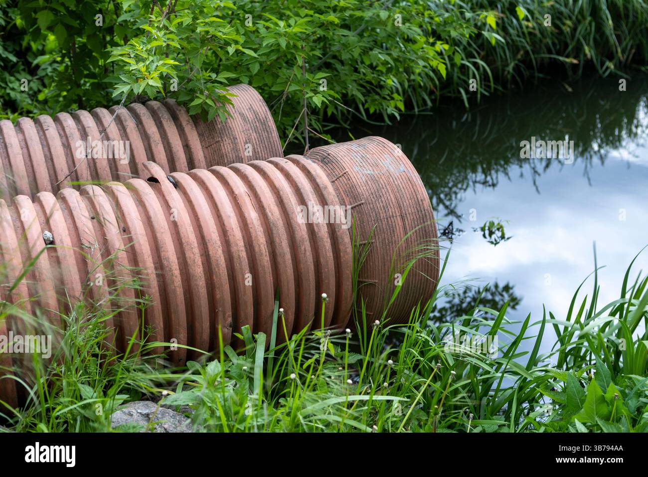 Concrete pipe of the rubble from which water flows into nature. Waste ...