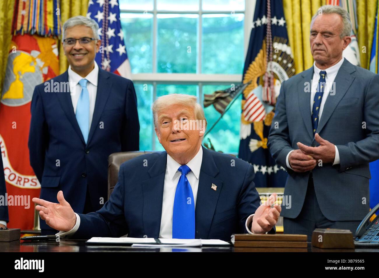 President Donald Trump speaks with reporters as he signs executive ...