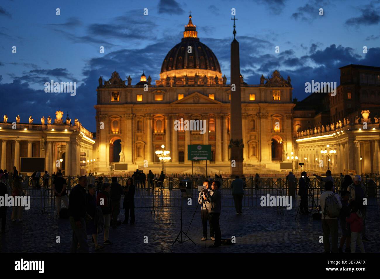 Journalists work next to St. Peter's Square, at the Vatican, on Monday ...