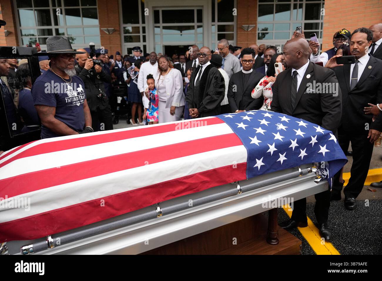 FILE - Friends and family of Roger Fortson watch as his casket leaves ...
