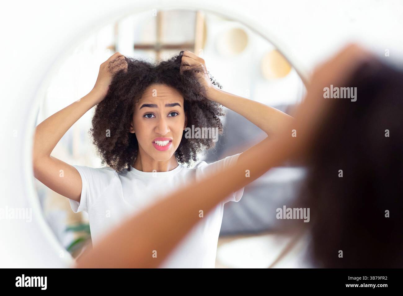 Upset young cute excited female touches curly hair and disappointed ...