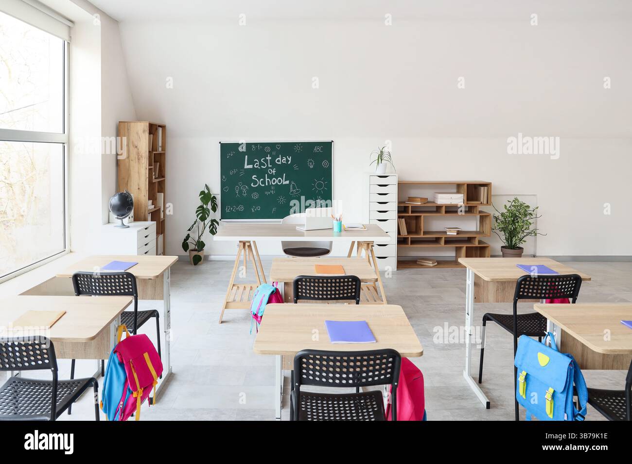 Interior of classroom with blackboard, shelf units and desks. End of ...
