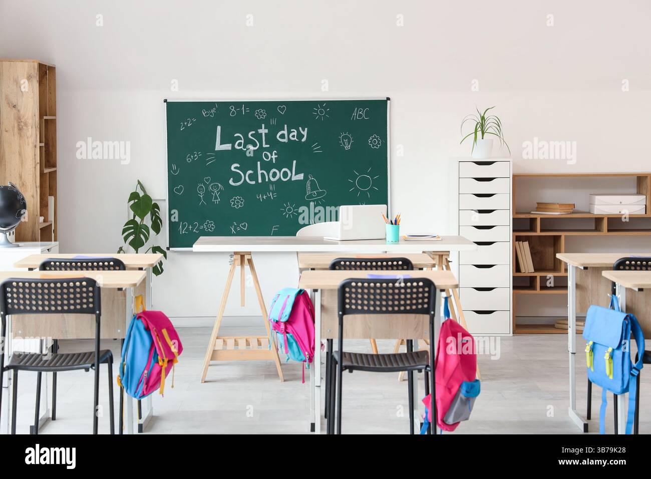 Interior of classroom with blackboard, shelf units and desks. End of ...