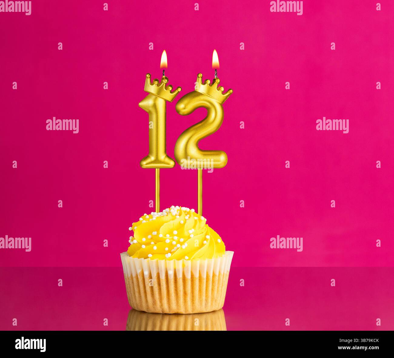 Yellow birthday cupcake with a number 12 candle - Birthday card on a ...