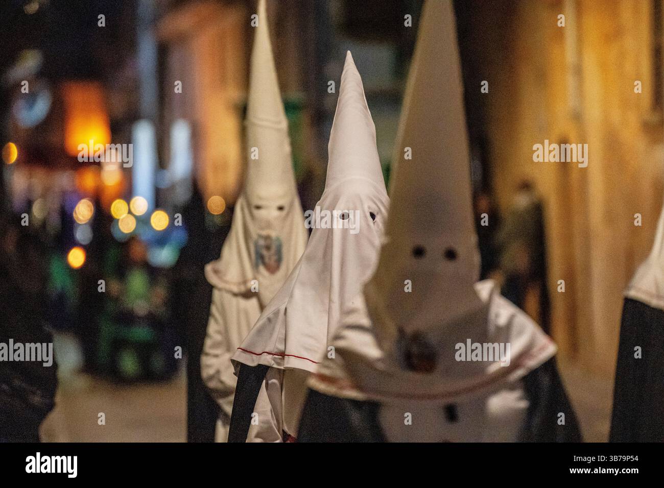 Hooded brothers with conical hats that serve as masks, Holy Week ...