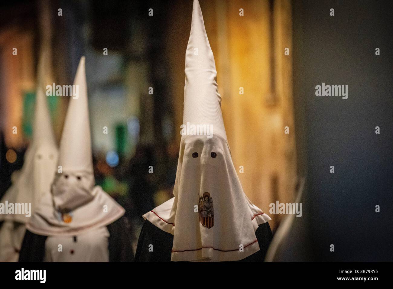 Hooded brothers with conical hats that serve as masks, Holy Week ...