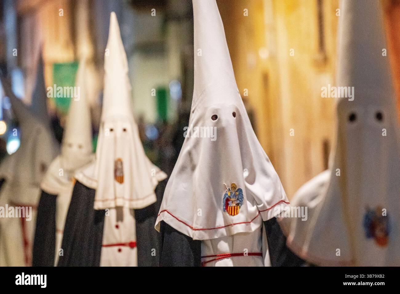 Hooded brothers with conical hats that serve as masks, Holy Week ...