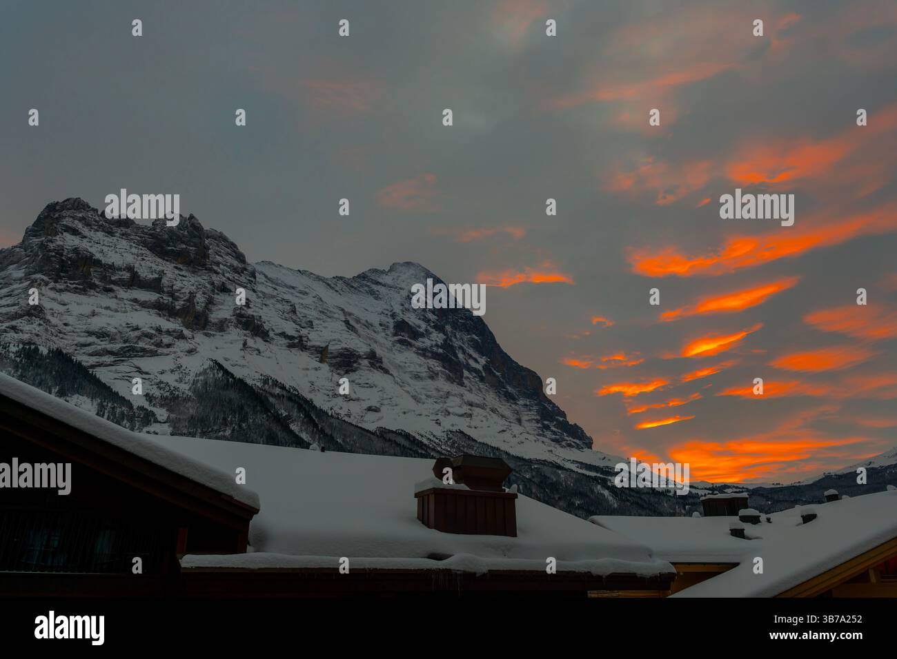 Rooftop and Mountain Peak Eiger in a Snowy Winter Night in Sunset in ...