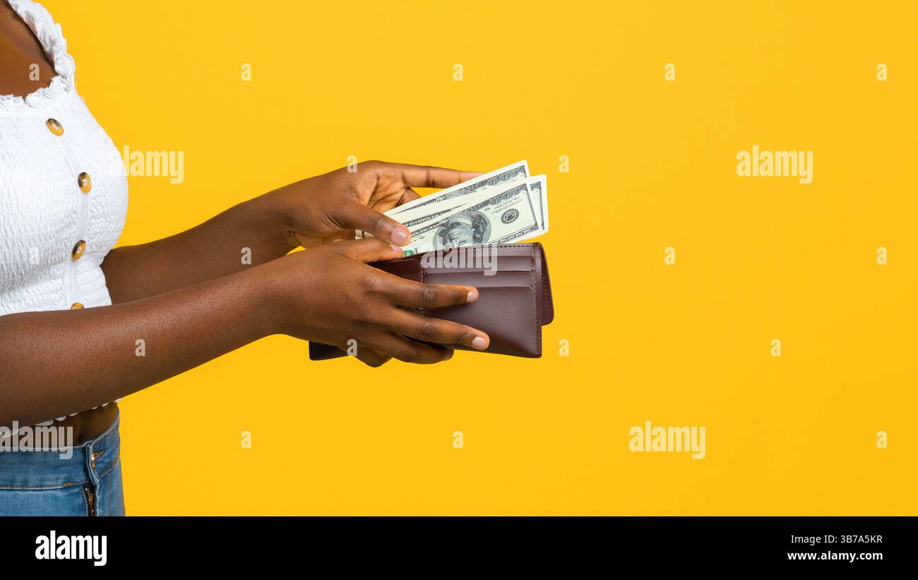 Finance, investment and money saving. Happy black woman putting ...