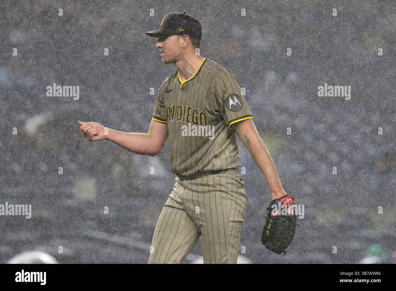 San Diego Padres pitcher Nick Pivetta stands in the rain during the ...
